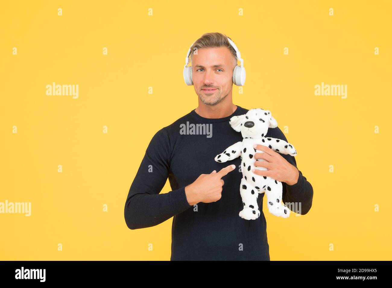 Its more then a toy. Handsome man point finger at toy dog. Toyshop ...