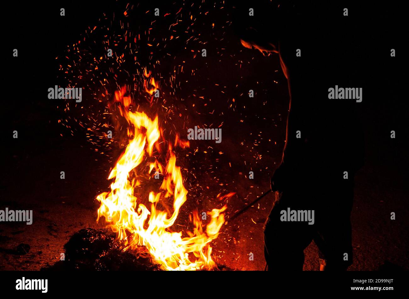 Boy in front of the fire of a bonfire Stock Photo - Alamy
