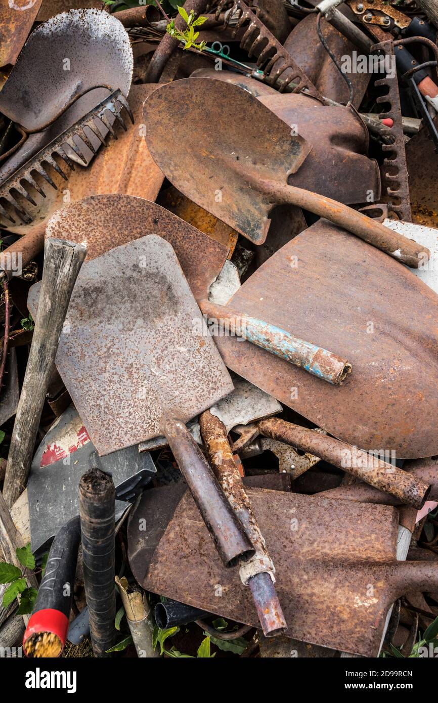 Rusted steel shovel heads and racks in a recycling facility Stock Photo ...
