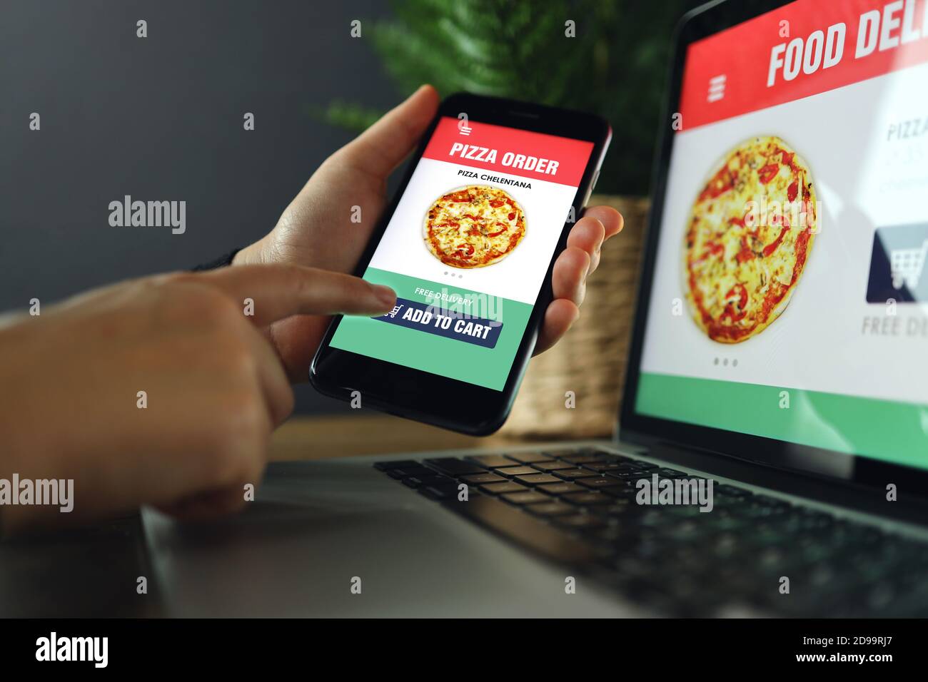 Food online order and delivery app on laptop and phone screens, man at ...