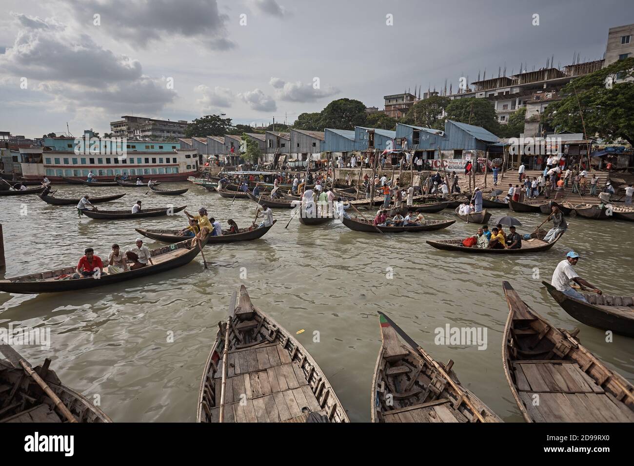 Dhaka, Bangladesh, July 2009. Passengers and rowers on the rowboats at ...