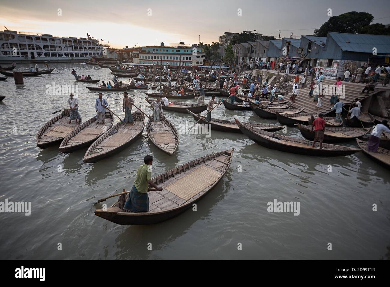Dhaka, Bangladesh, July 2009. Passengers and rowers on the rowboats at ...
