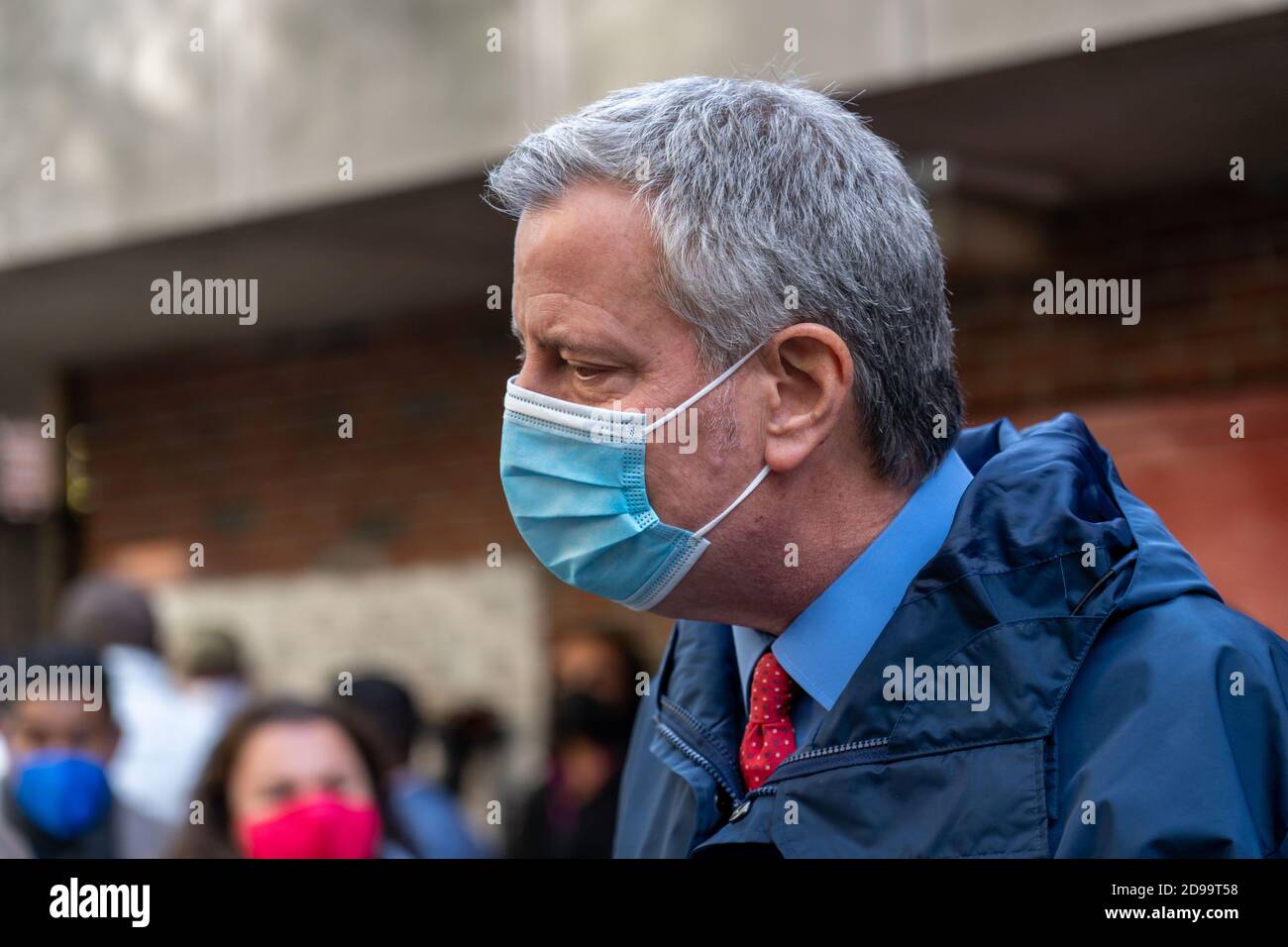 New York City Mayor Bill de Blasio wearing a face masks speaks to the ...