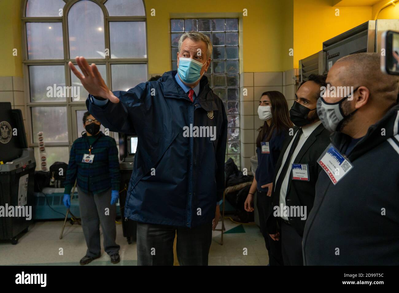 New York City Mayor Bill de Blasio wearing a face mask greets staff ...