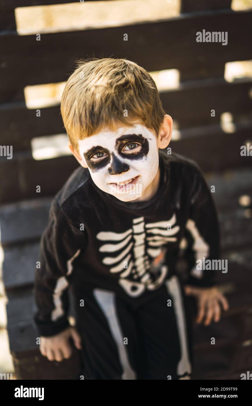 Cute little boy wearing a Halloween skeleton costume Stock Photo - Alamy