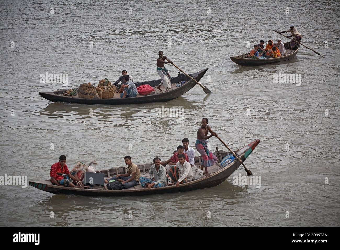 Dhaka, Bangladesh, July 2009. Passengers and rowers on the rowboats at ...