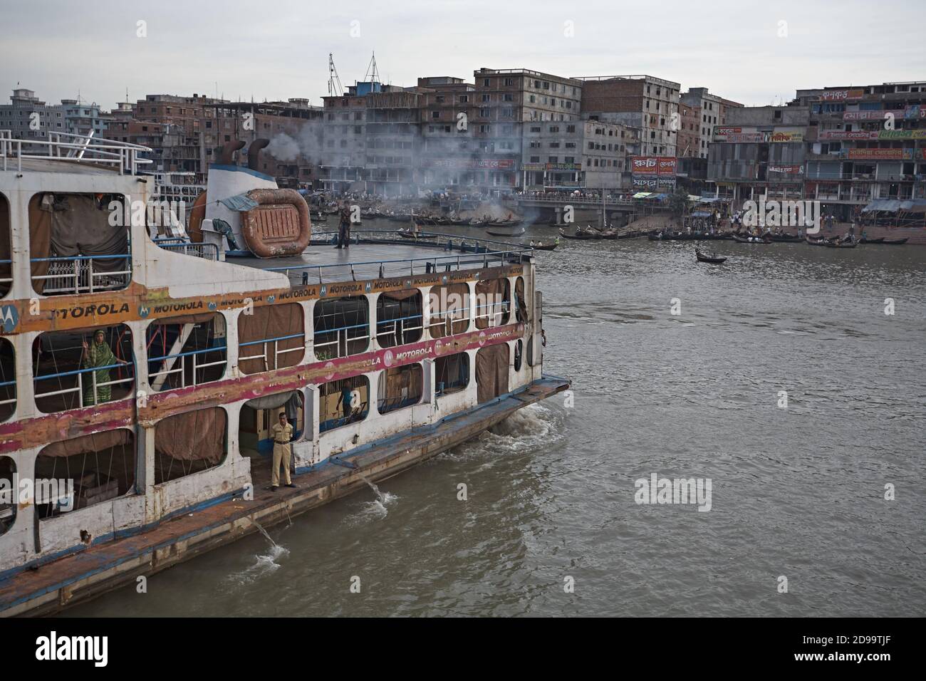 Dhaka, Bangladesh, July 2009. Passengers and rowers on the rowboats at ...