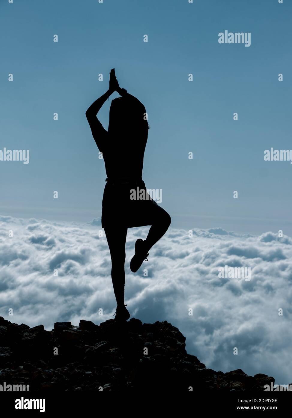 yoga pose silhouette above the clouds Stock Photo - Alamy