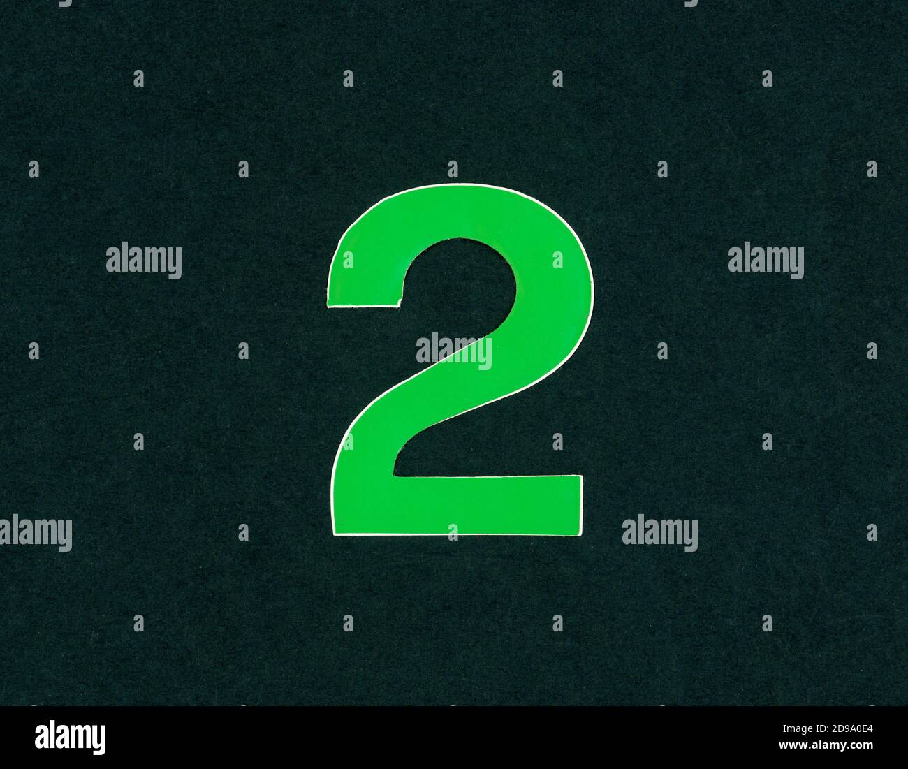 Green number two digit over black background Stock Photo - Alamy