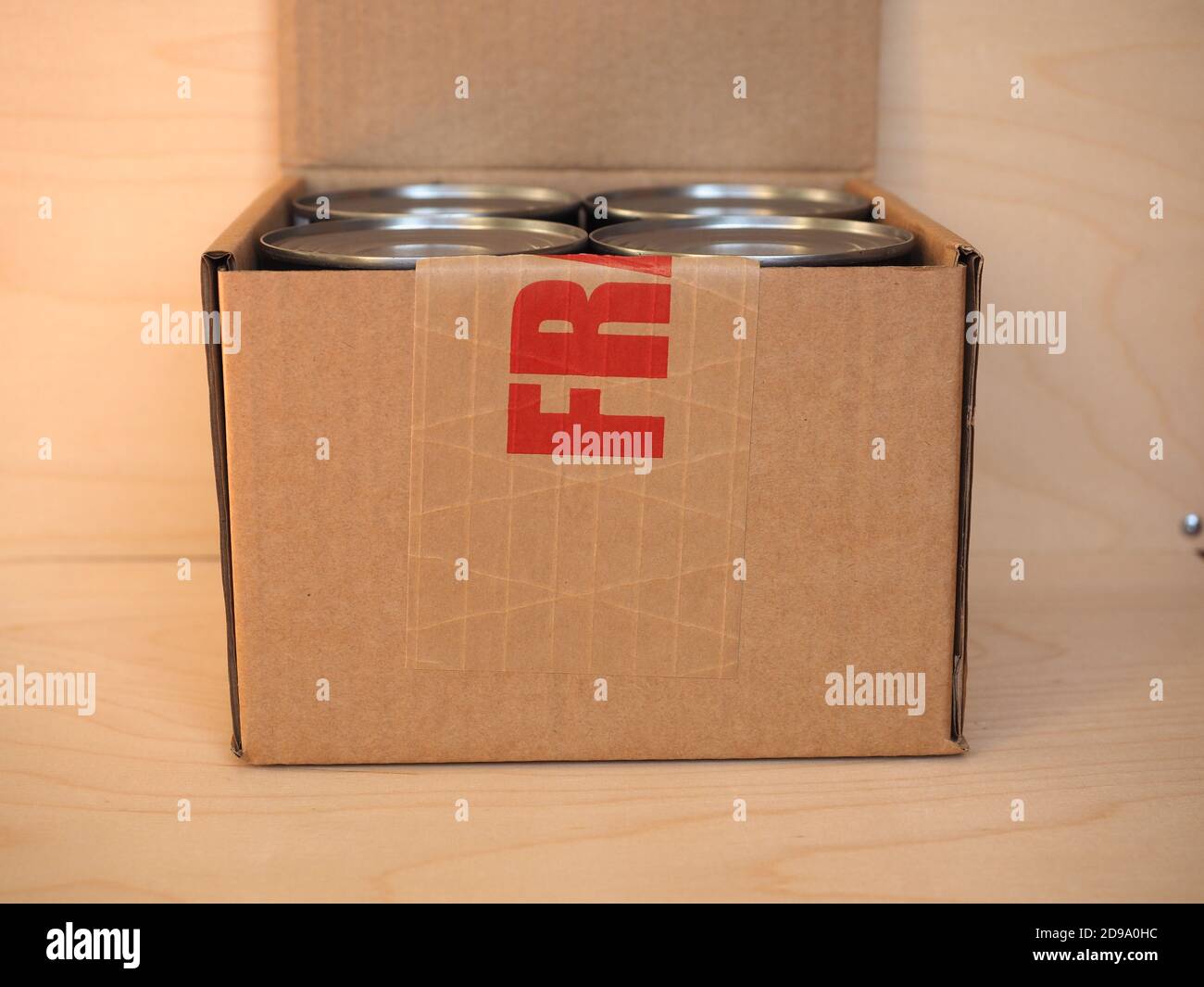 Fragile corrugated cardboard box packet parcel with tin cans Stock Photo - Alamy