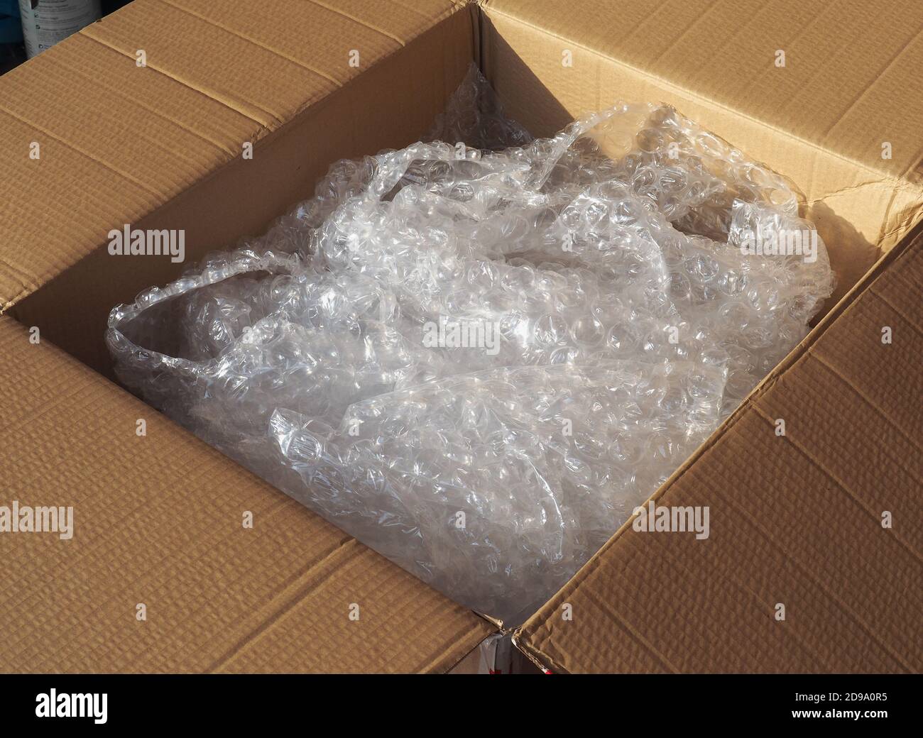 corrugated cardboard packet filled with bubble wrap Stock Photo - Alamy