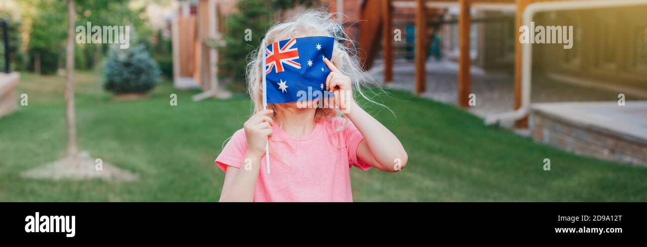 Girl holding Australian flag. Funny child kid covering her face with ...