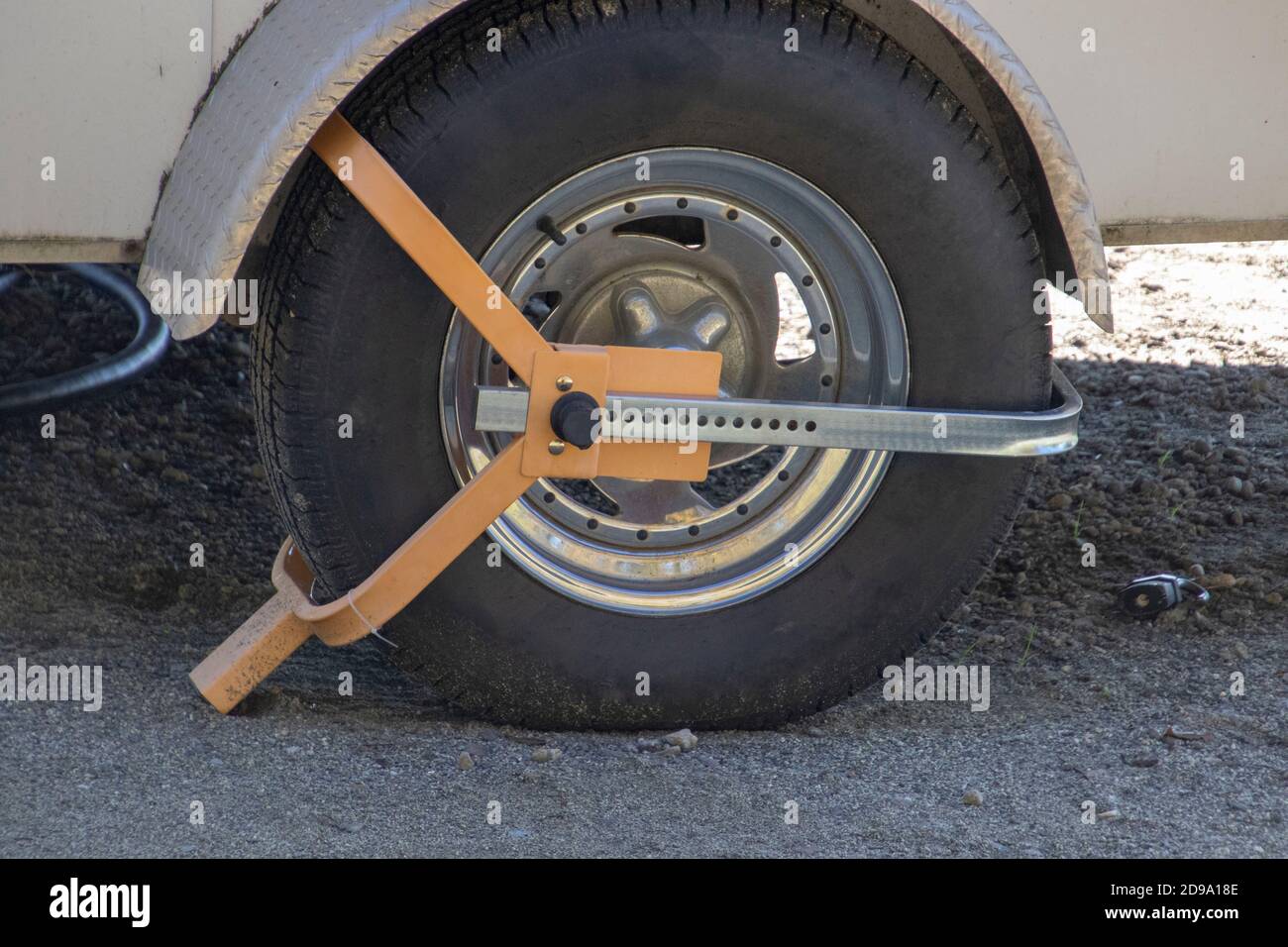 A tire boot around a tire preventing the car from being moved located ...