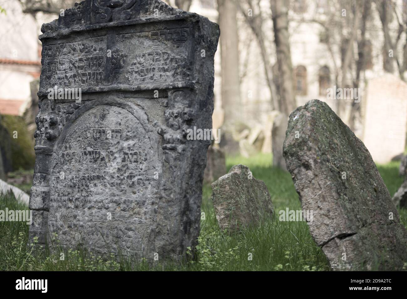 Closeup of Hebrew engravings on old stones in a graveyard under the ...