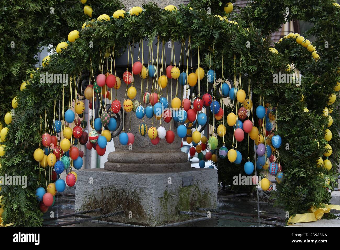 Festive arrangement of colorful Easter egg decors hanging from arches ...