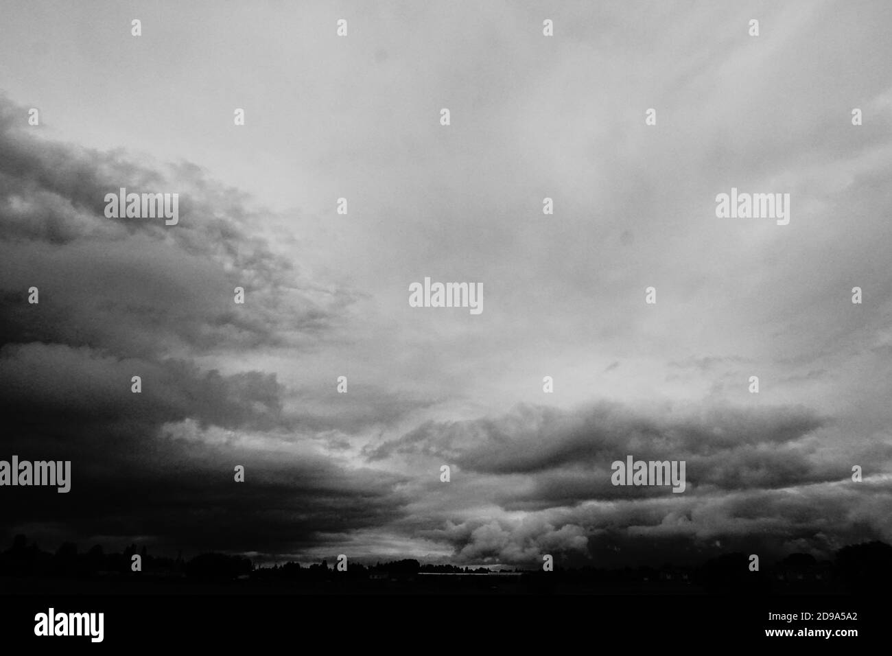 Grayscale shot of dark clouds in the sky Stock Photo - Alamy
