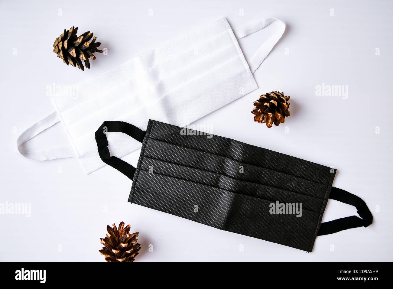 Protective medical white and black face mask with pine cones on white ...