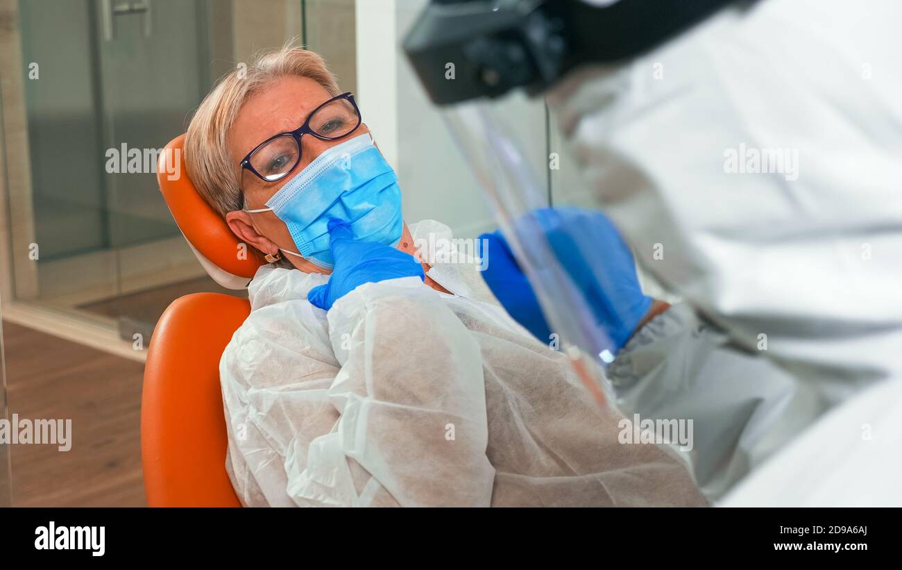 Portrait on senior patient wearing protection mask with teeth ache ...