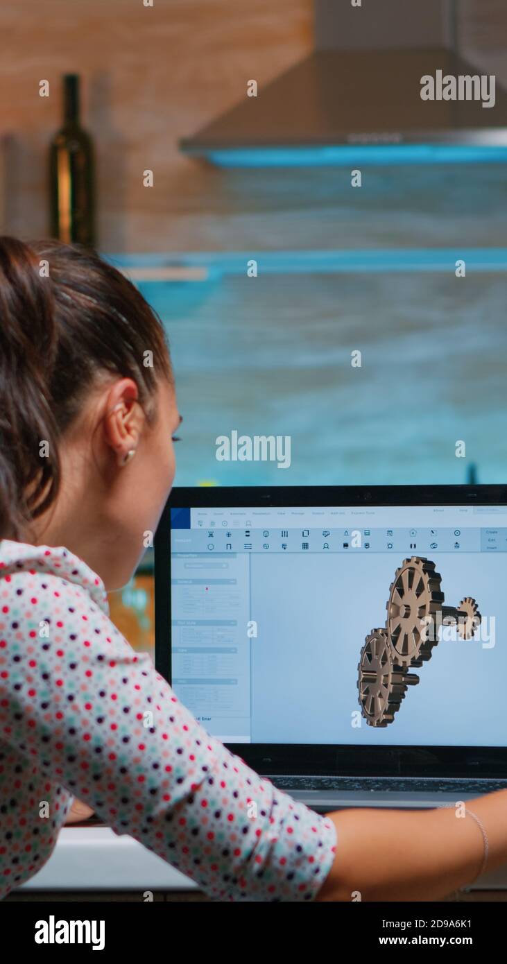 Young remote woman architect working on modern cad program overtime ...