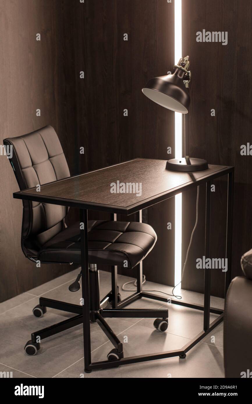 Chair and table with lamp Stock Photo - Alamy