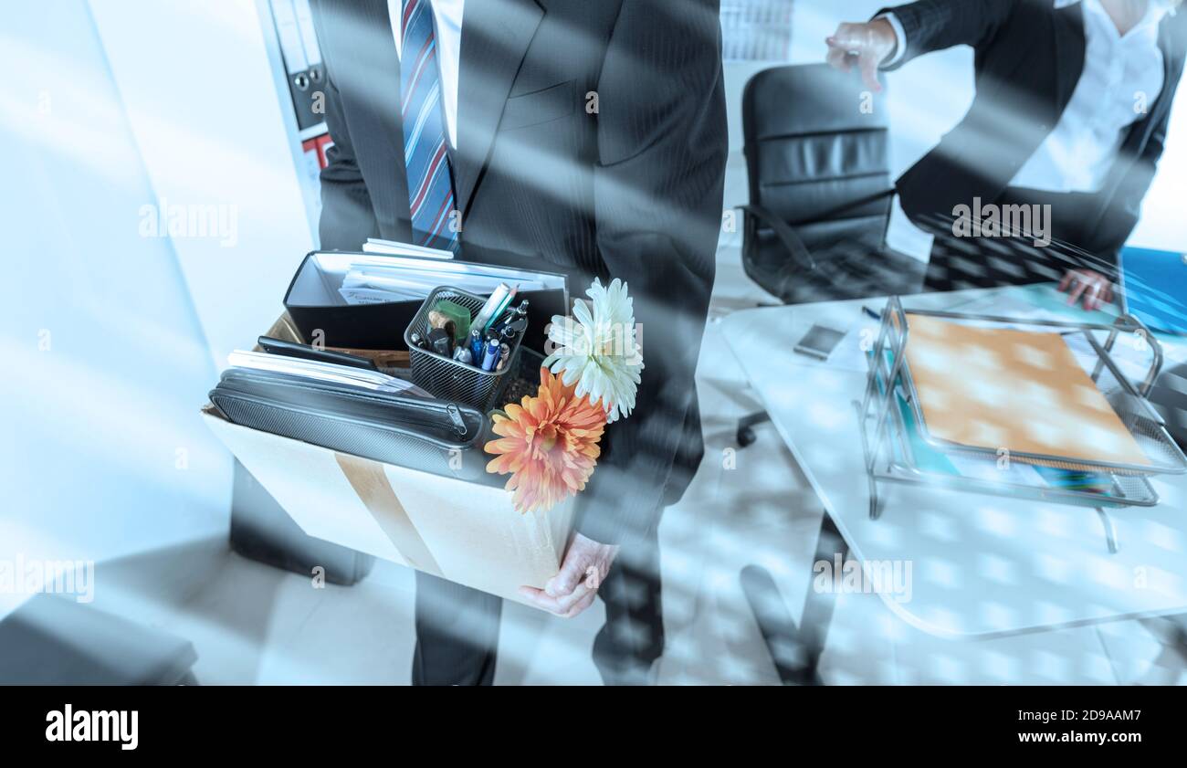 Employee laid off by a businesswoman; light effect Stock Photo - Alamy