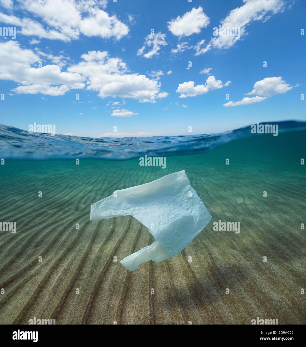 Plastic pollution in the ocean, a plastic bag underwater and blue sky ...