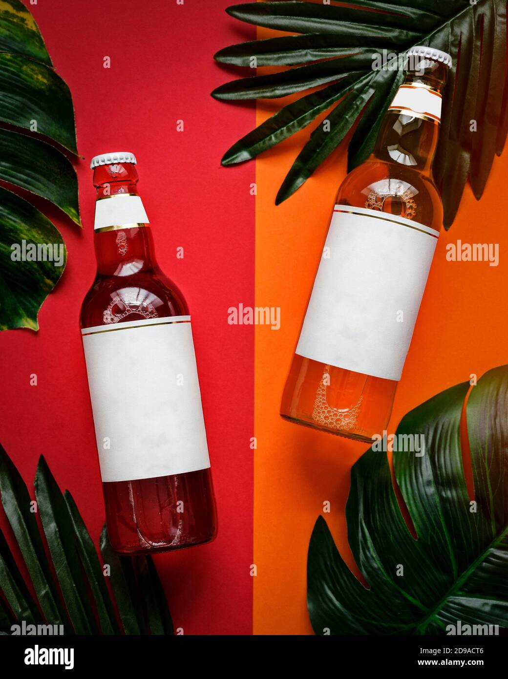 Glass bottles with colourful drink inside on a colourful background ...