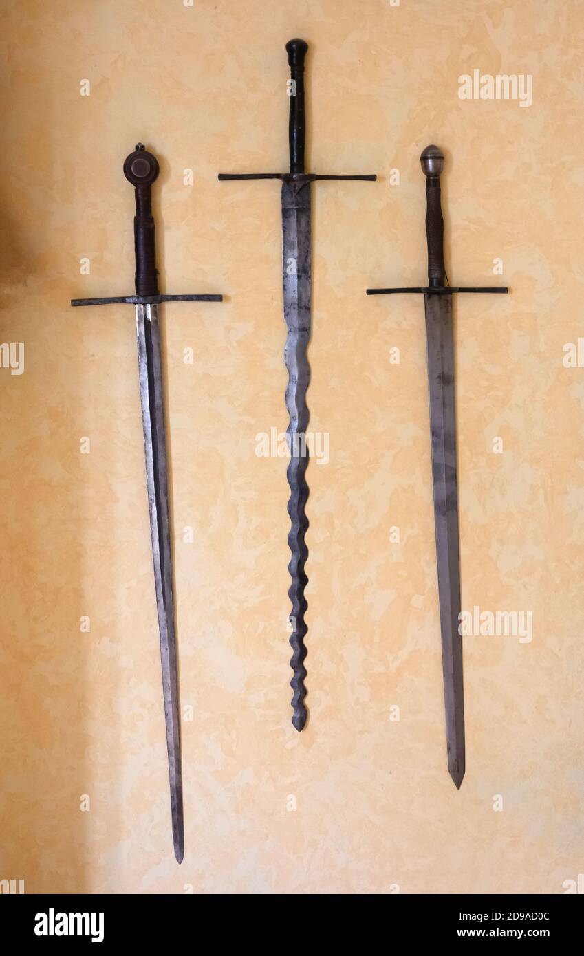 Ancient swords mounted on a yellow wall Stock Photo - Alamy