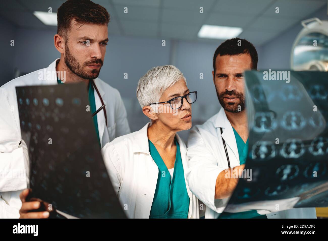 Group of doctors examining an x-ray in hospital to make diagnosis Stock ...