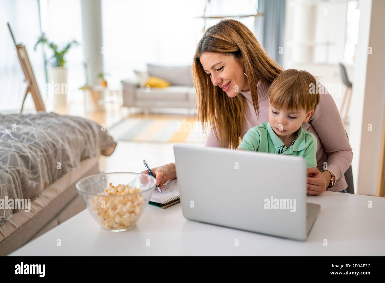 Busy family mother and child at home working on the computer Stock ...