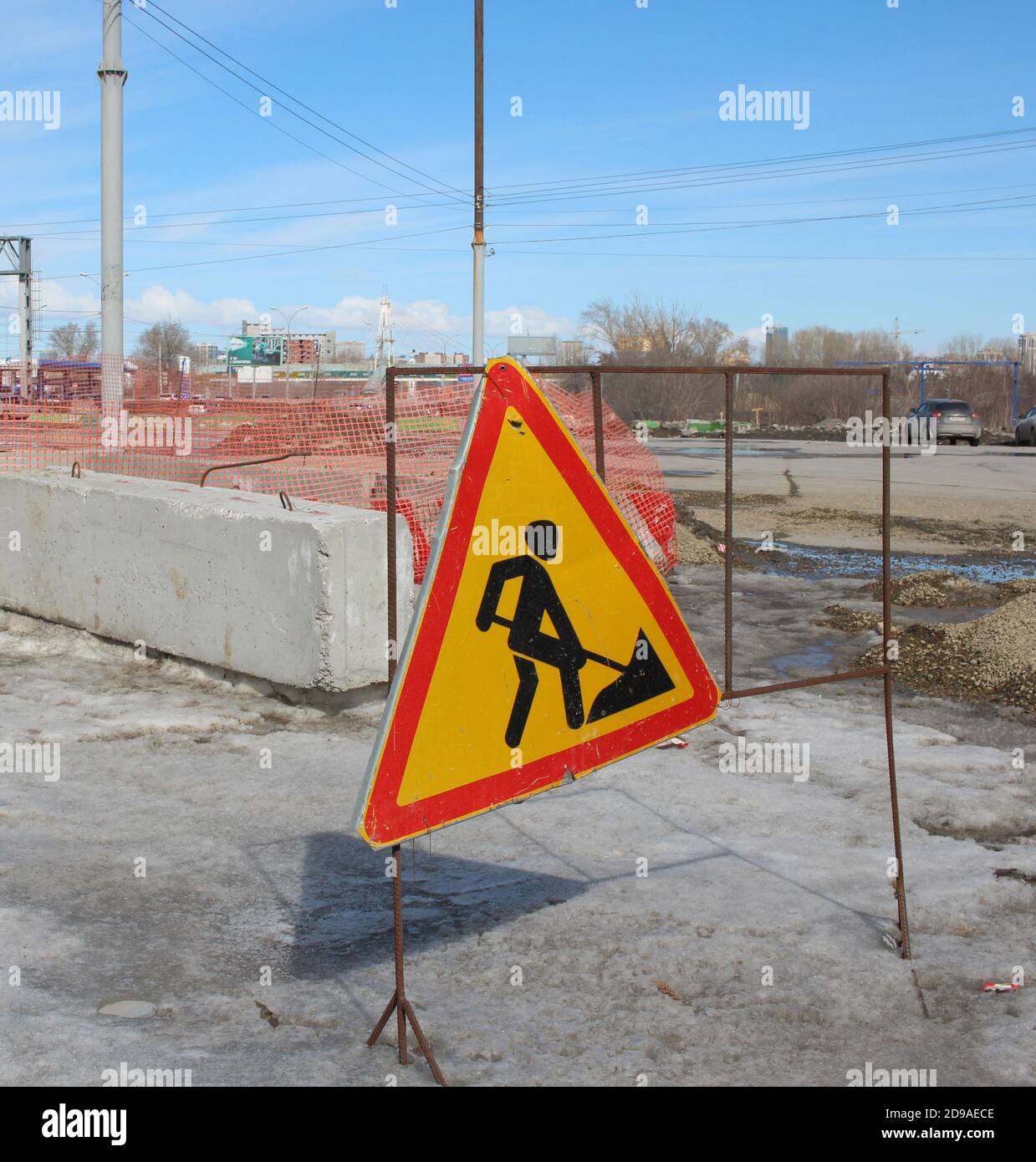 warning sign road works for repair man with a shovel Stock Photo - Alamy