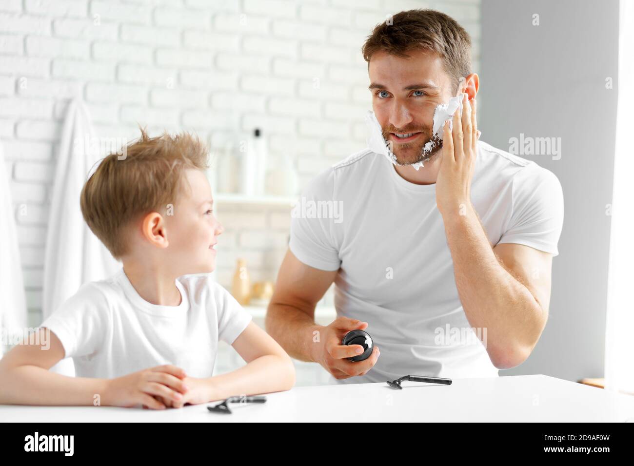 Father teaches his little son how to shave face Stock Photo - Alamy