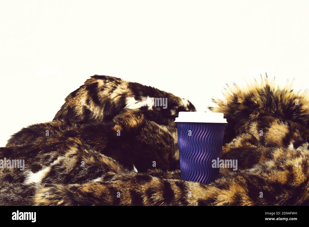 Blue color paper or plastic coffee cup with spotted fluffy fur coat ...