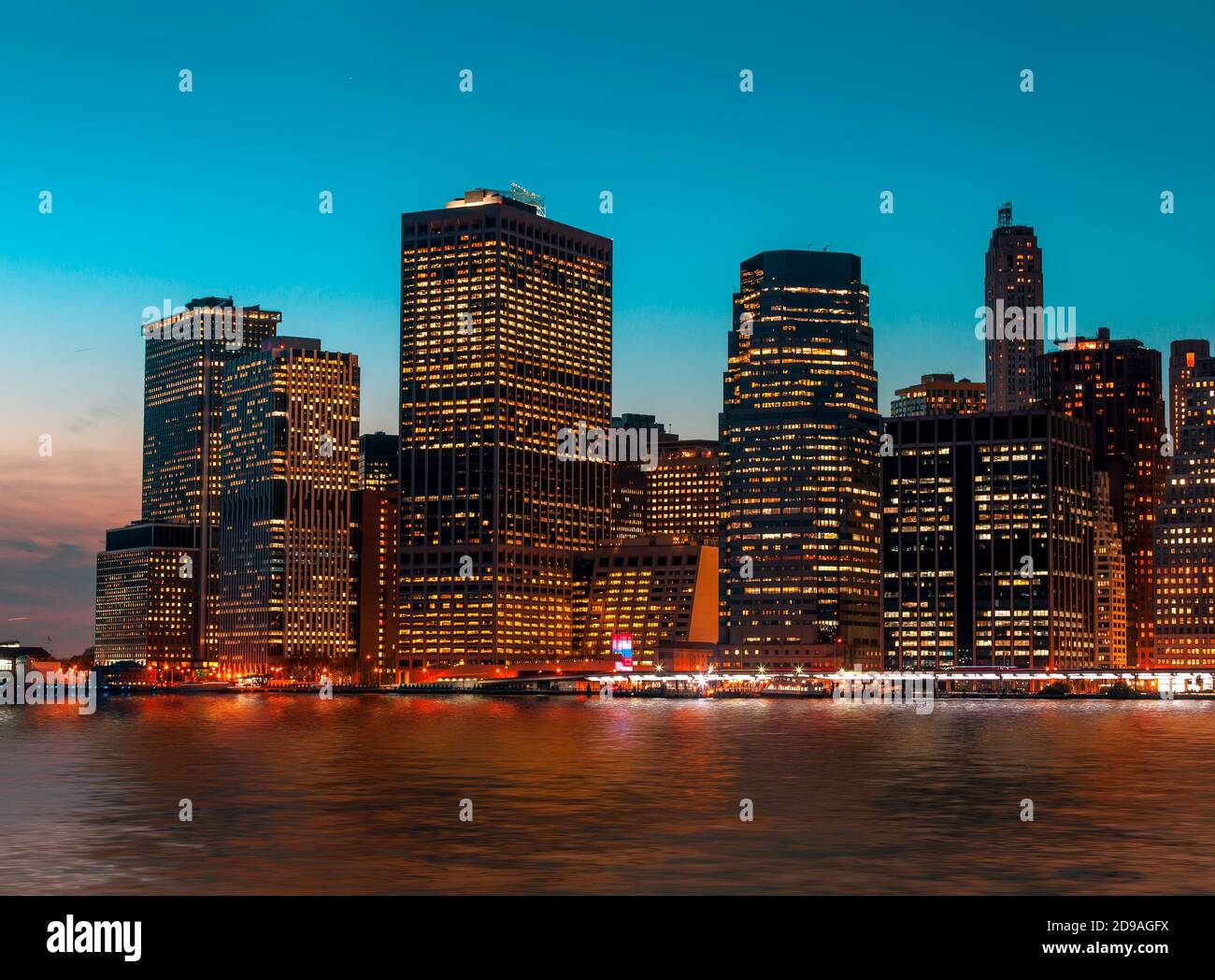 Manhattan at night with lights and reflections. New York City skyline ...