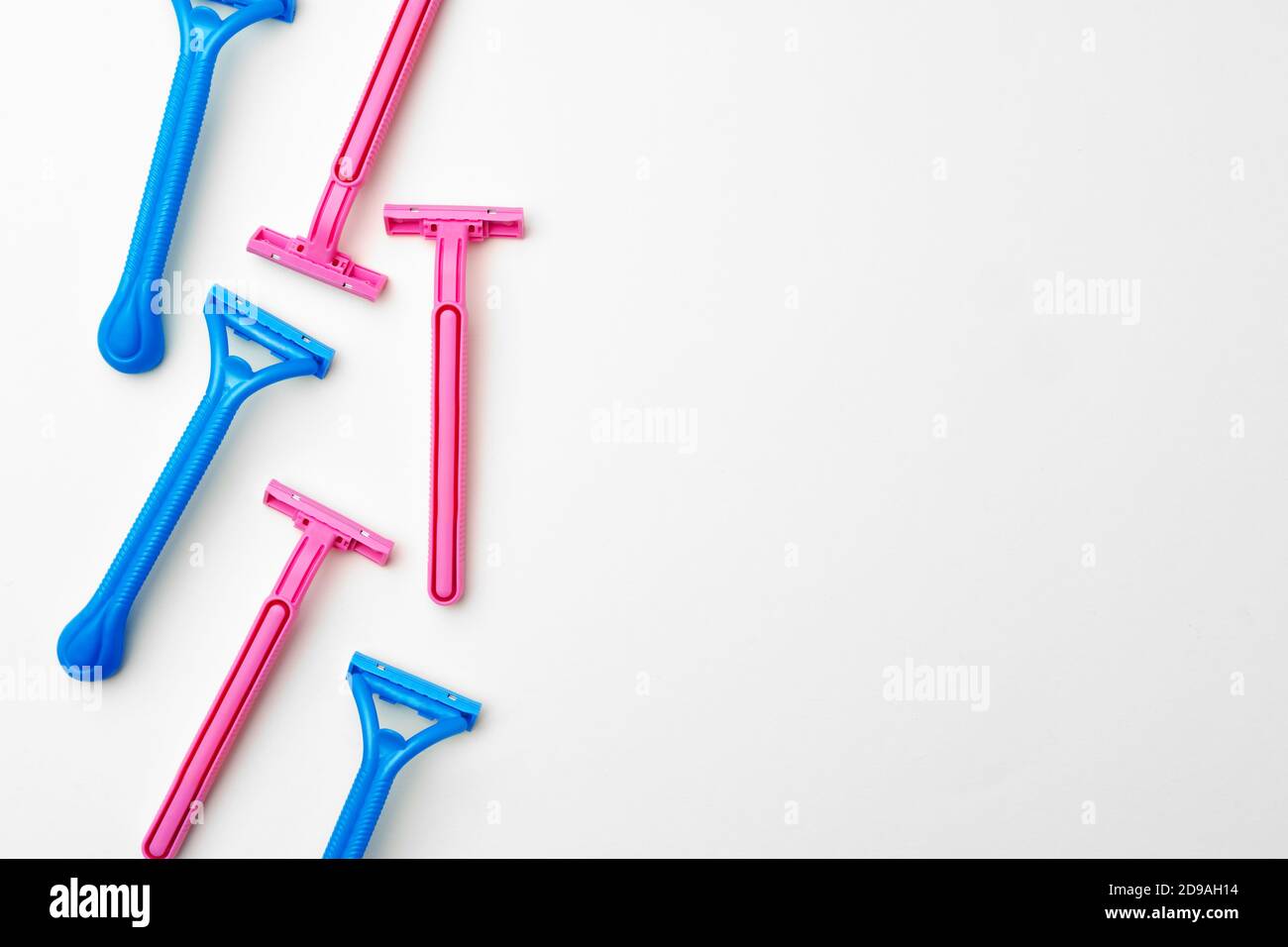 Pink and blue razors on white background Stock Photo - Alamy