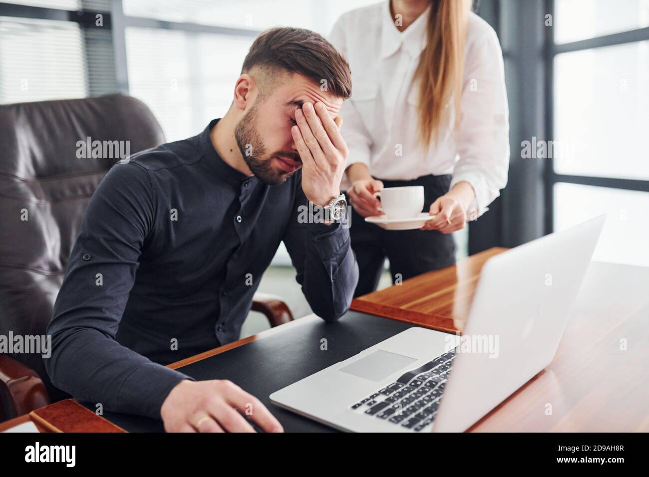 Guy feels bad. Woman and man in formal clothes working together indoors ...