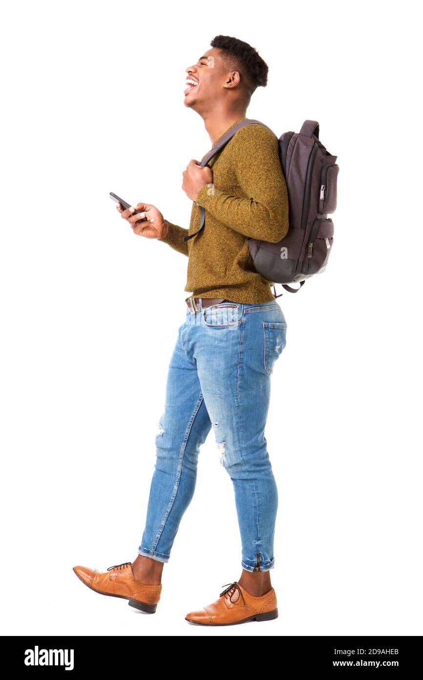 Full body side portrait of happy young african american man walking on ...