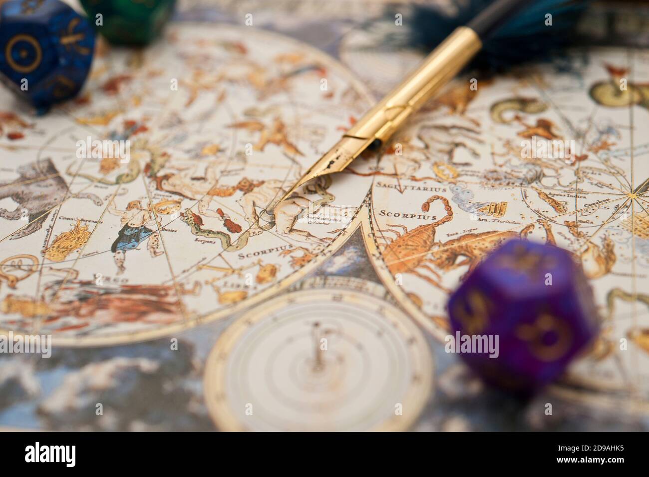 antique astrology chart with zodiac signs and dice with a quill pen ...