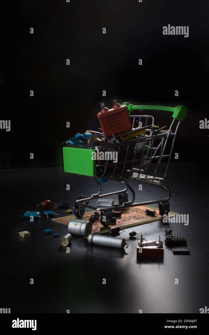 Metal trolley shopping cart, filled with radio components, stands on an ...