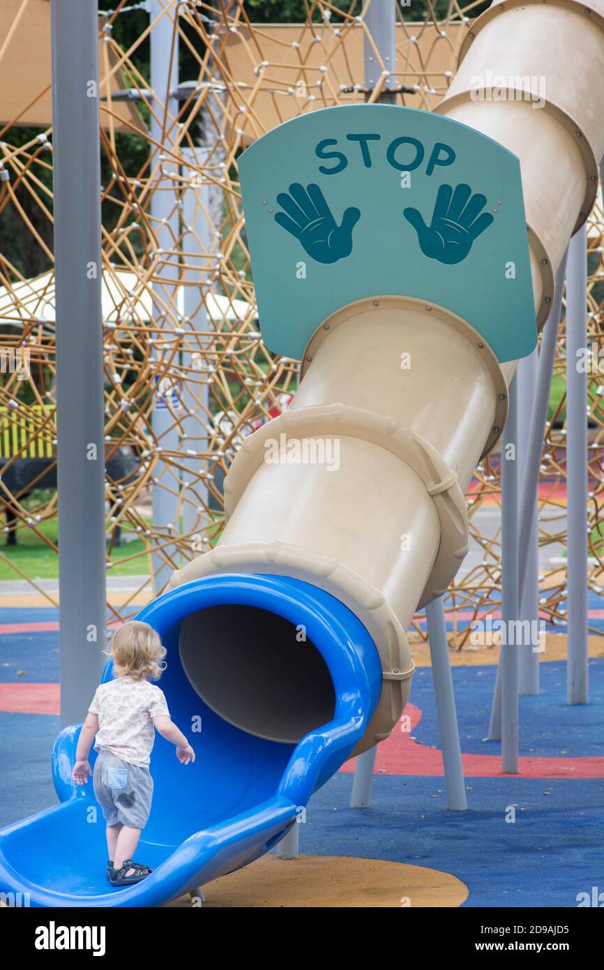 "Stop" sign in a playground, preventing kids from climbing the tube ...