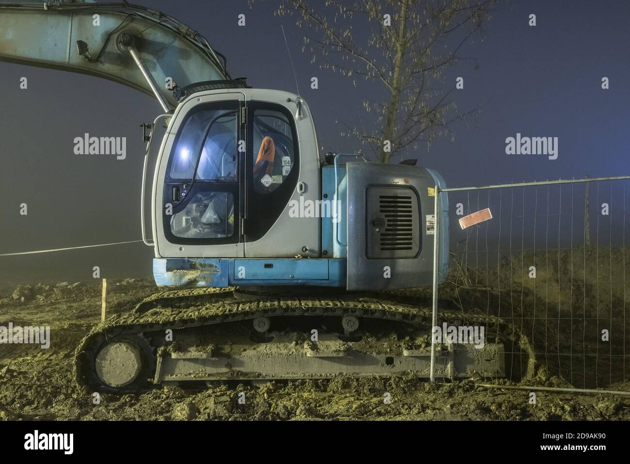 Blue excavator digger working at night on the street Stock Photo - Alamy