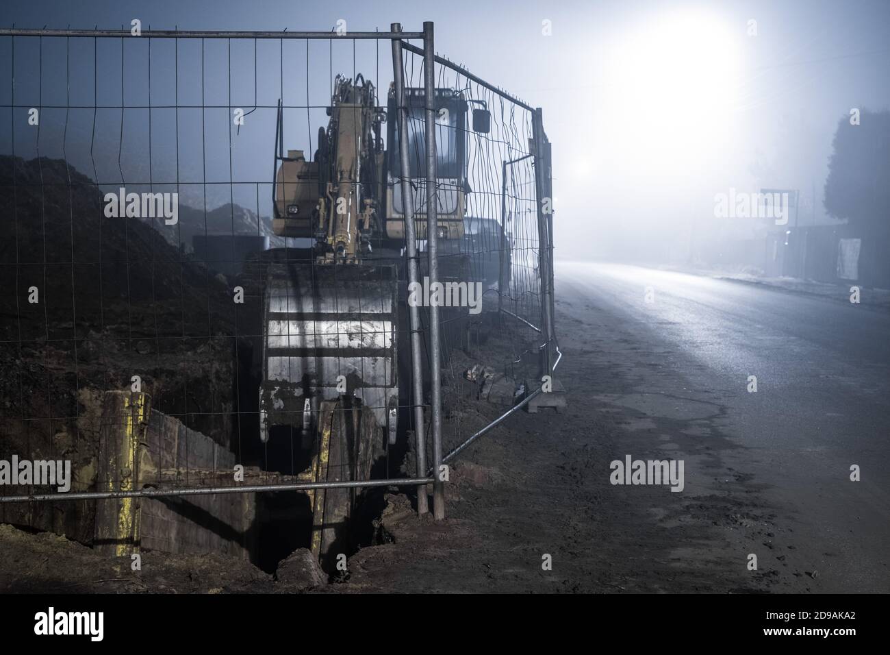 Blue excavator digger working at night on the street Stock Photo - Alamy