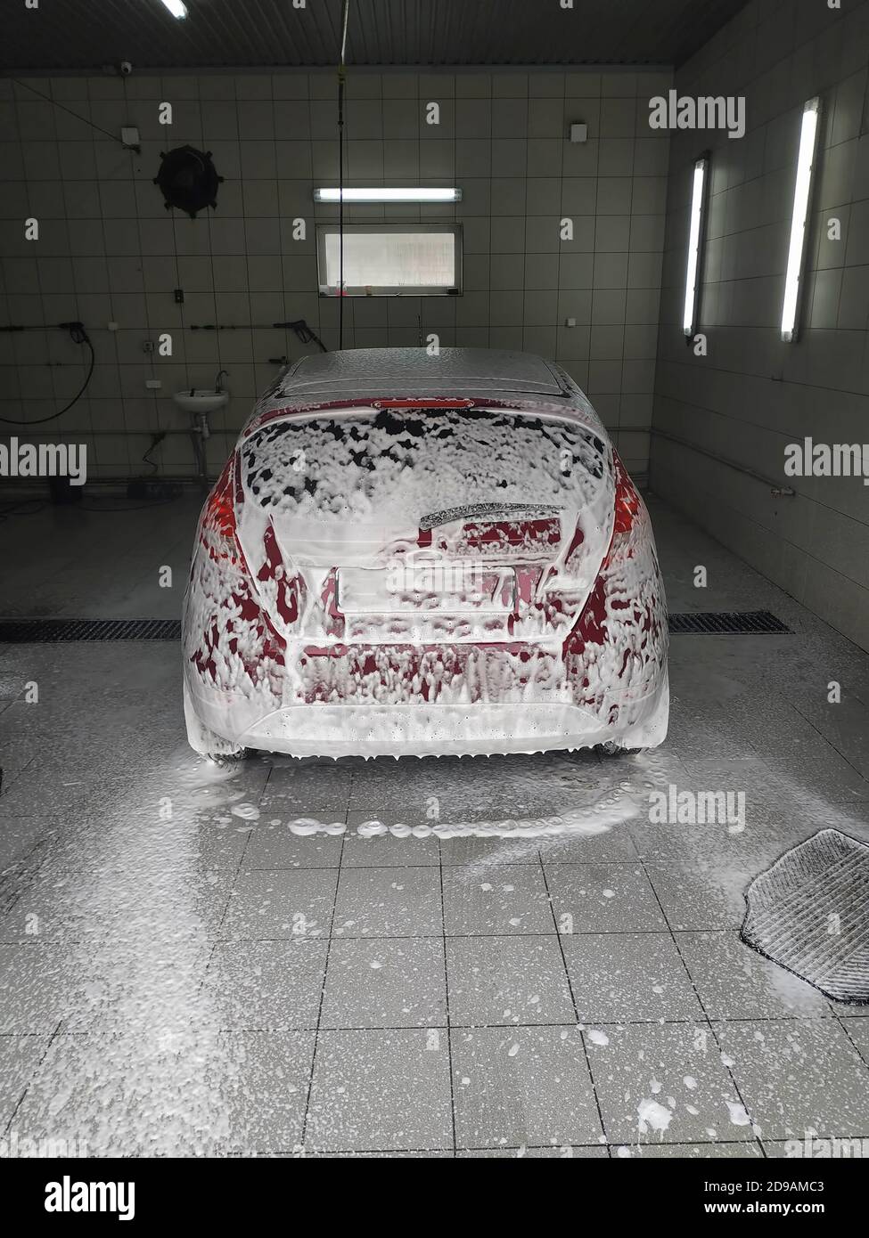 Wet and soapy red car at the car wash Stock Photo - Alamy