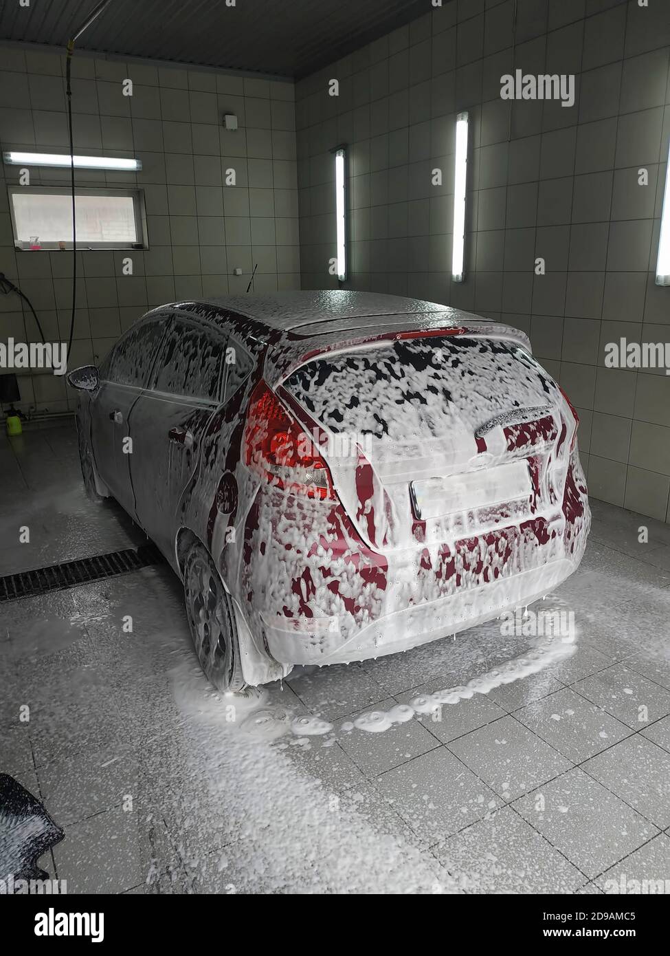 Wet and soapy red car at the car wash Stock Photo - Alamy