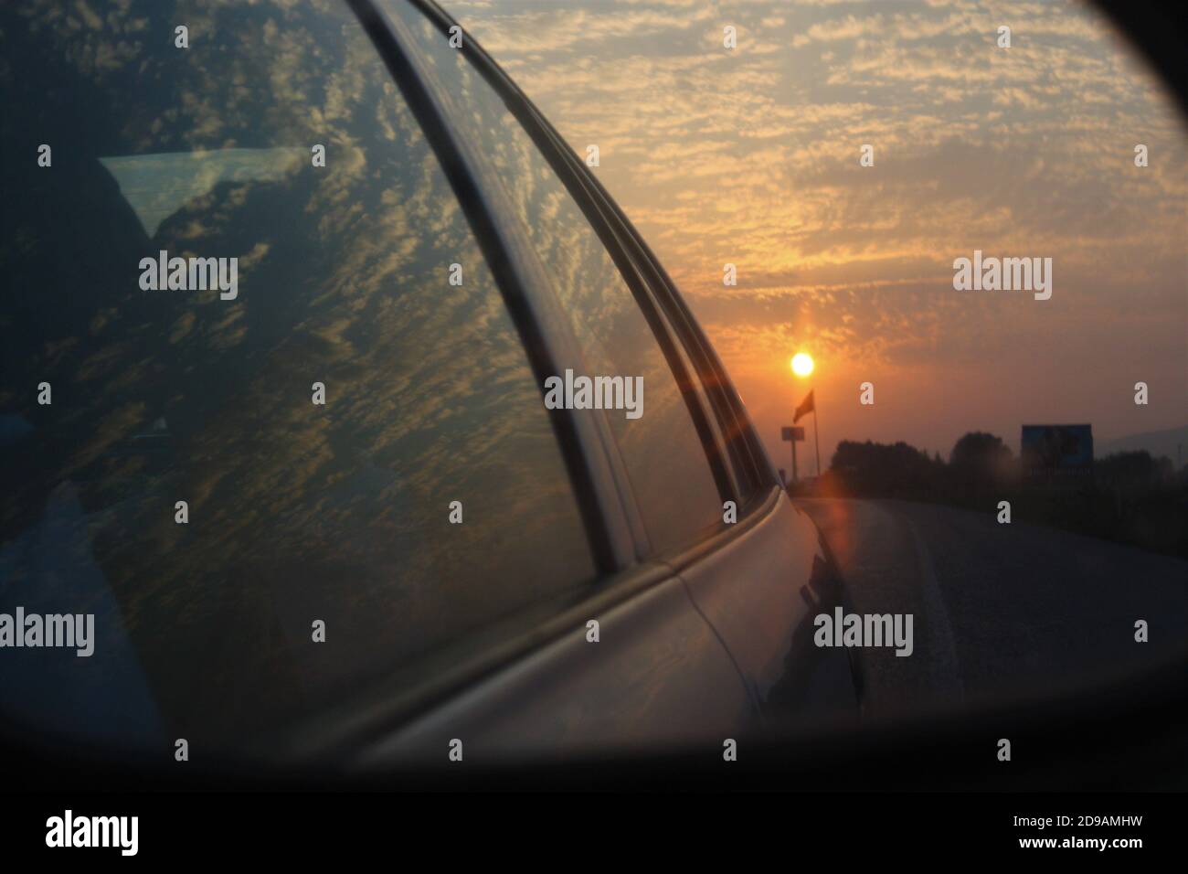 Sun photo from mirror rear.Sun rising photo taken from rear mirror of a ...