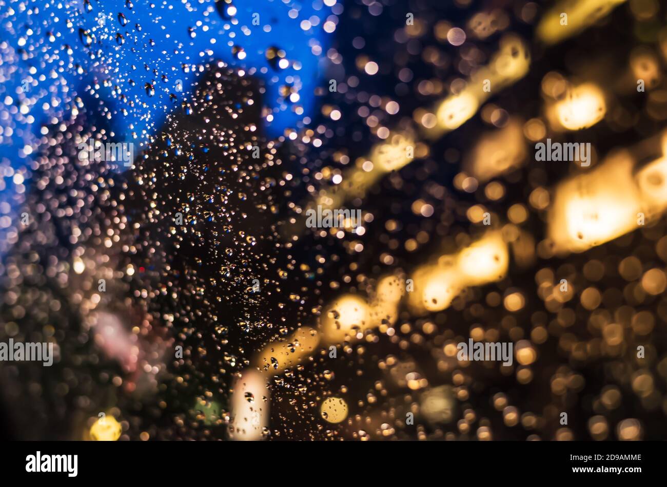 Blurred New York City street background with waterdrops, neon lights ...