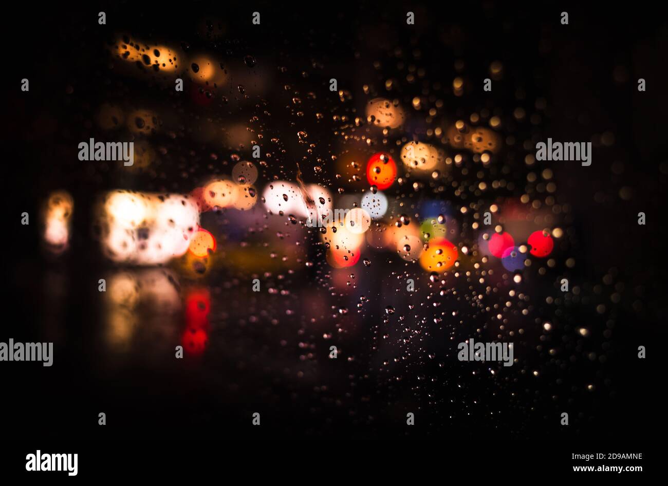 Blurred New York City street background with waterdrops, neon lights ...