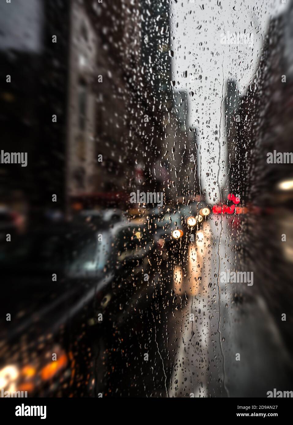 Blurred New York City street background with waterdrops, lights and ...