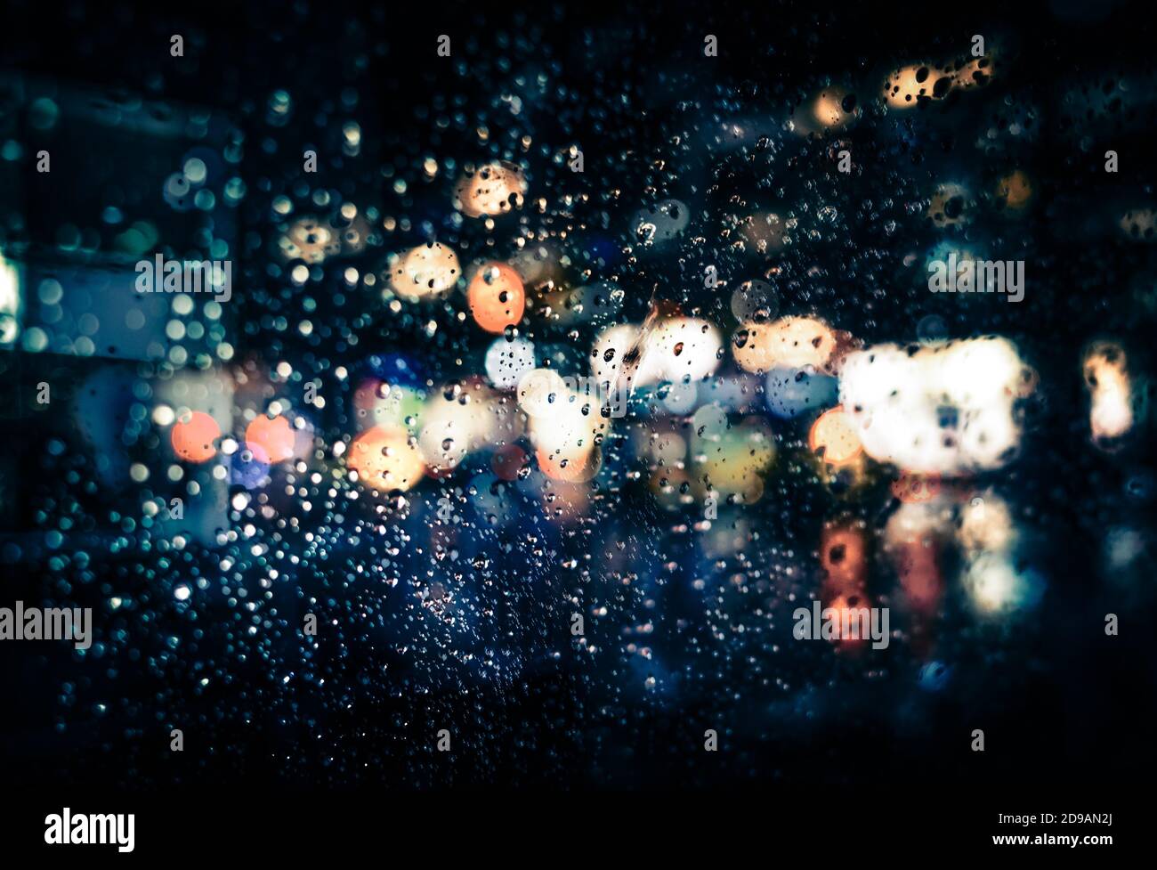 Blurred New York City street background with waterdrops, neon lights ...