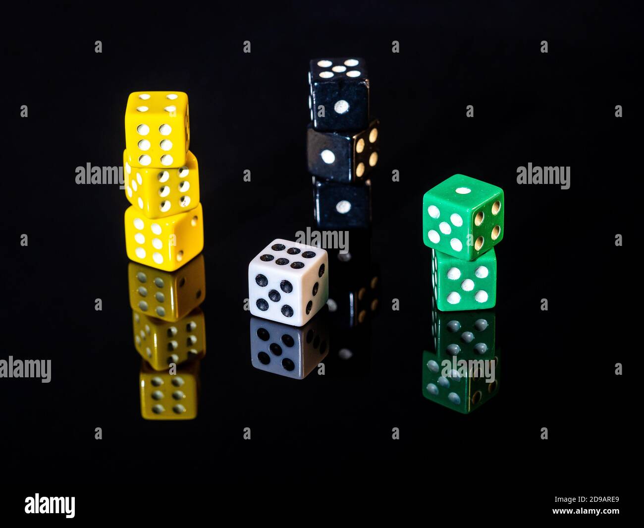 Stack of dice in various colors isolated on black background Stock ...